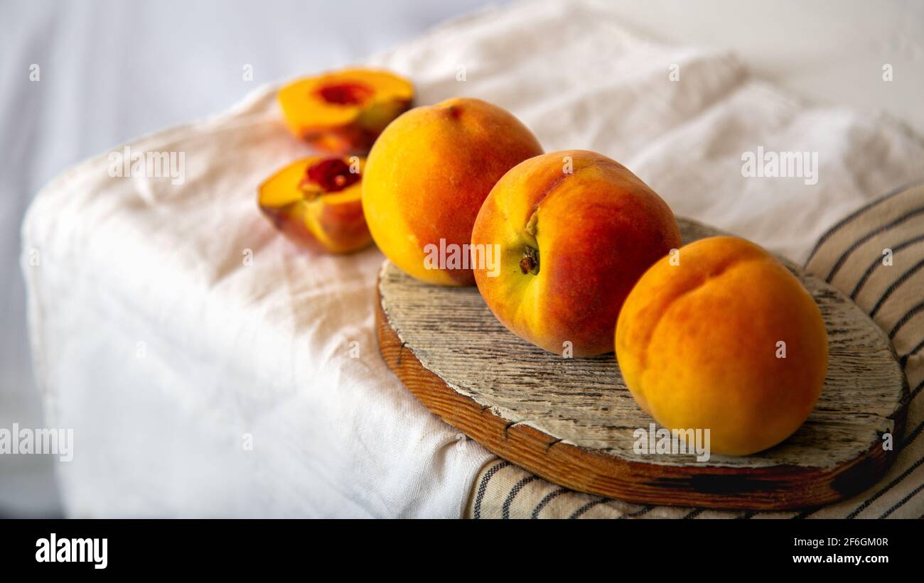 Peaches on table in kitchen near window. Rustic minimalism food peach ...
