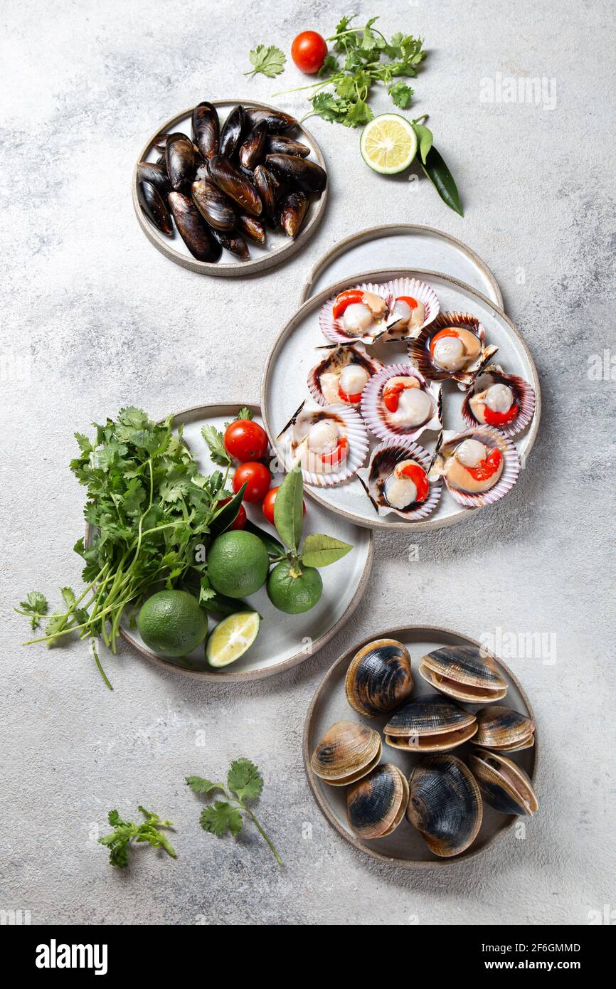Seafood shellfish clams, mussels and scallops on gray plates Stock ...