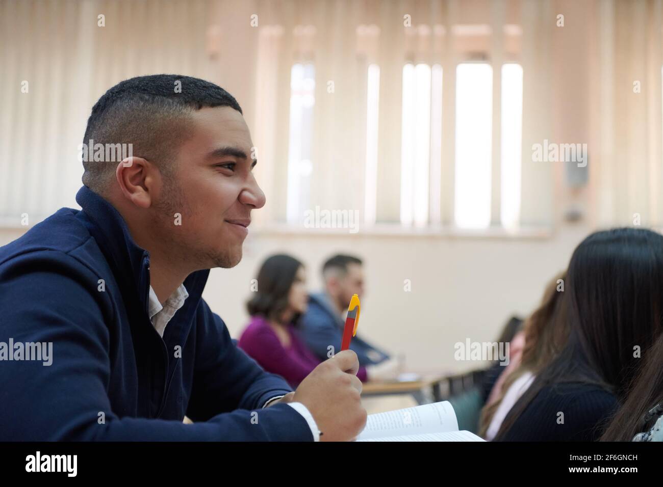 student taking notes while studying in high school. Satisfied young man ...