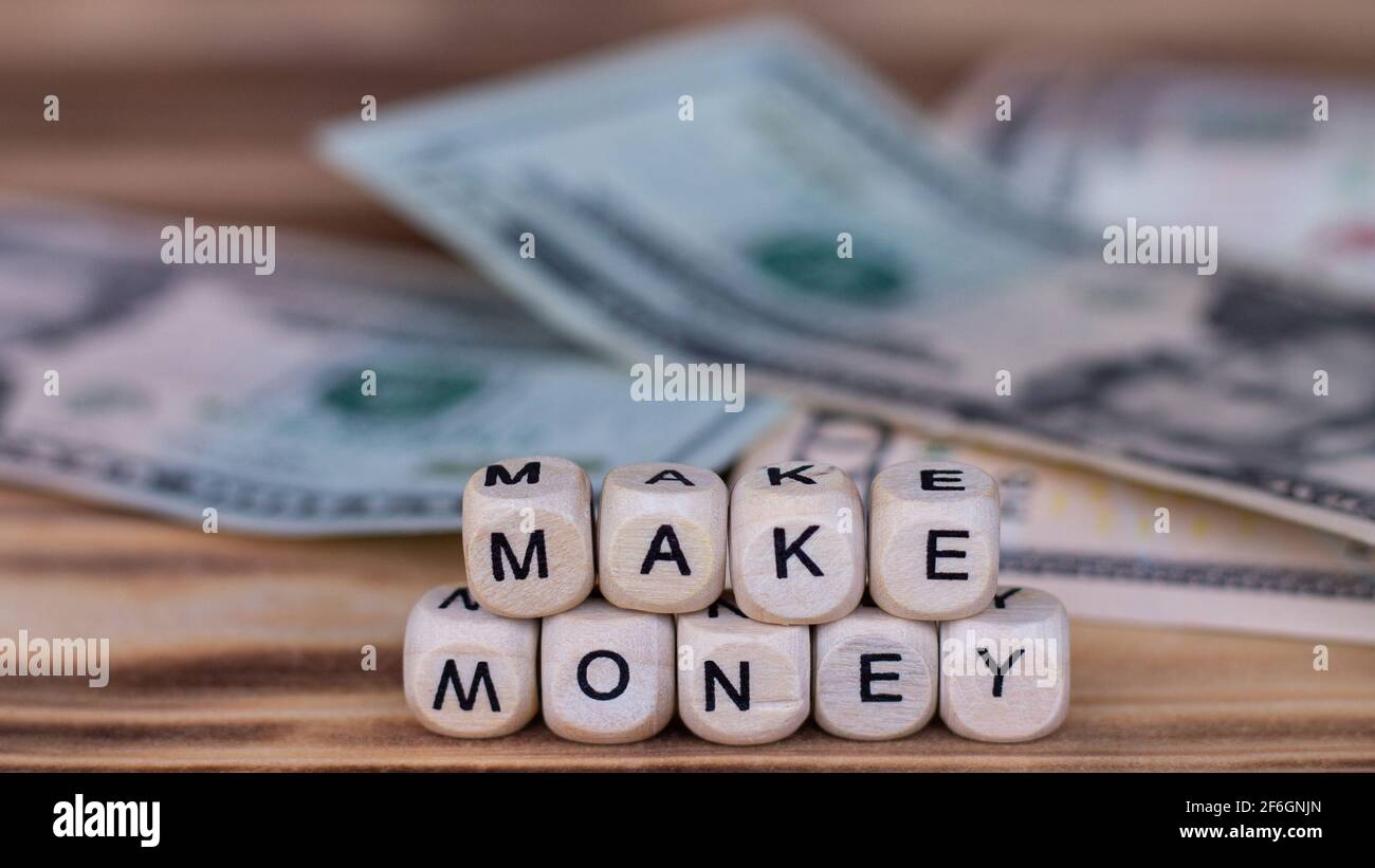 The words Make Money, lined with letters on wooden cubes on the ...