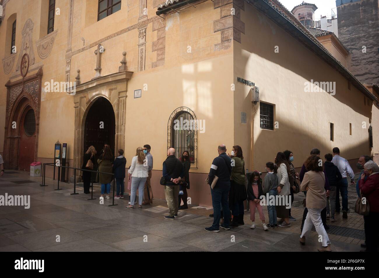 People in a queue waiting to enter Santiago church, as part of worships ...