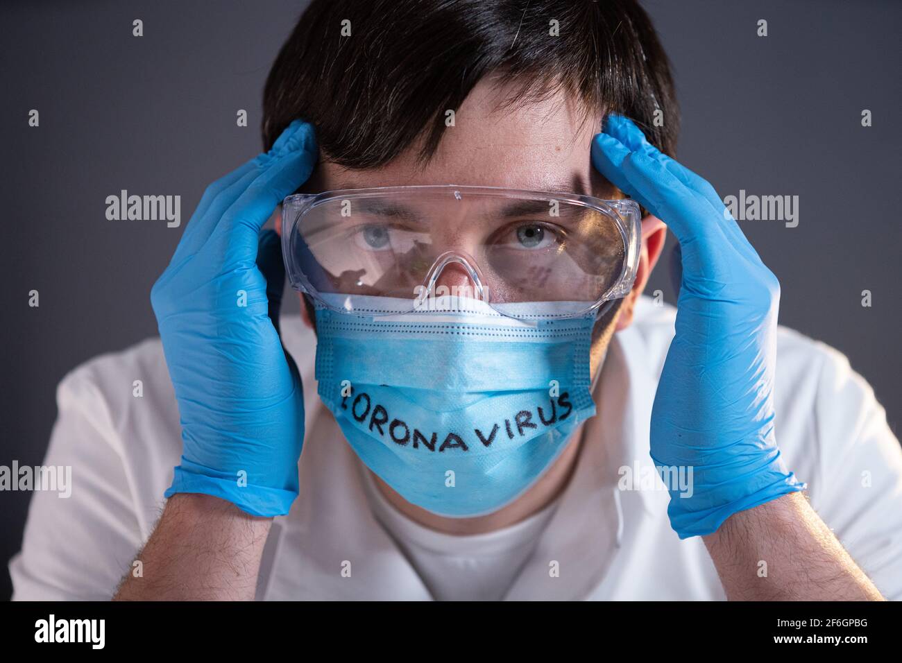 Tired, exhausted, devastated doctor scientist, after long shift, head ...