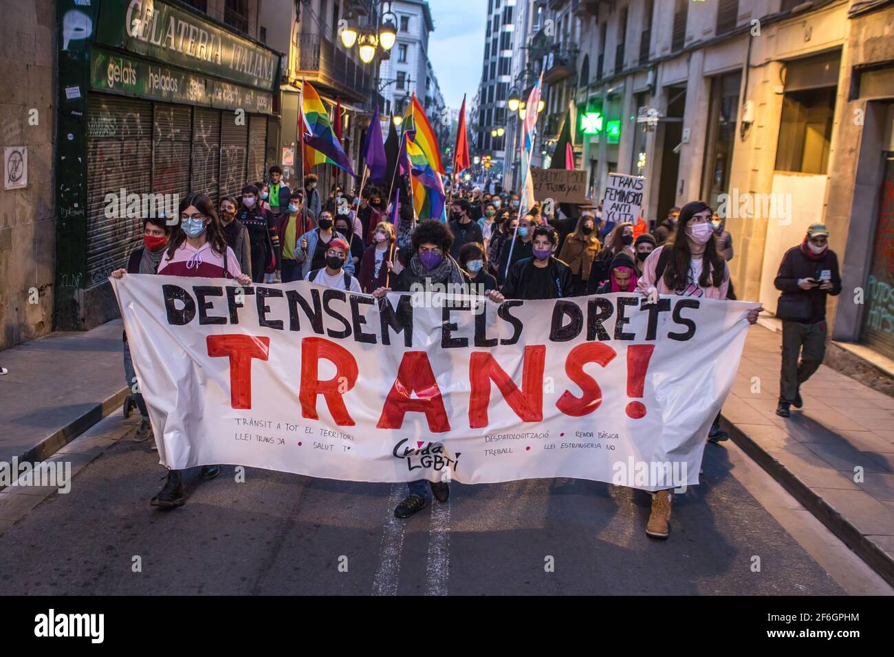 Protesters hold a banner that says We defend trans rights during the ...