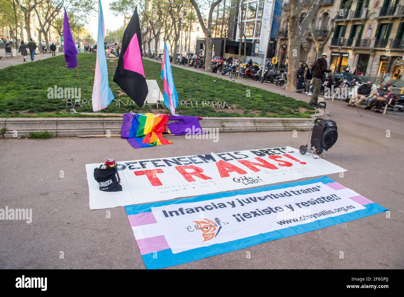 Transgender flags and banners are seen during the demonstration. On the ...