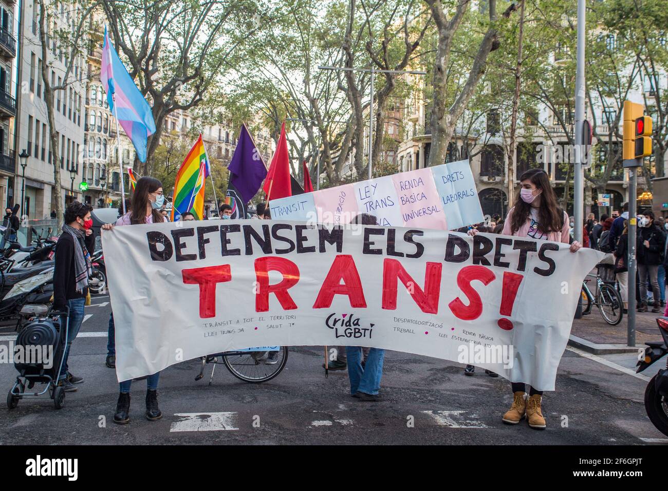 Protesters hold a banner that says We defend trans rights during the ...