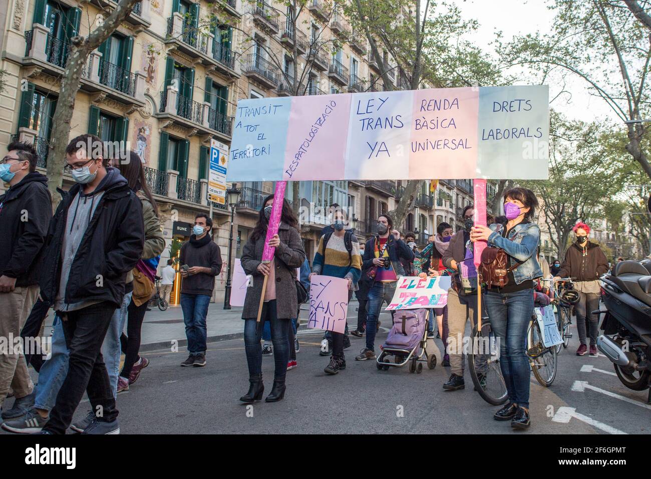 Demonstrators hold a banner that says, transit in all territories ...