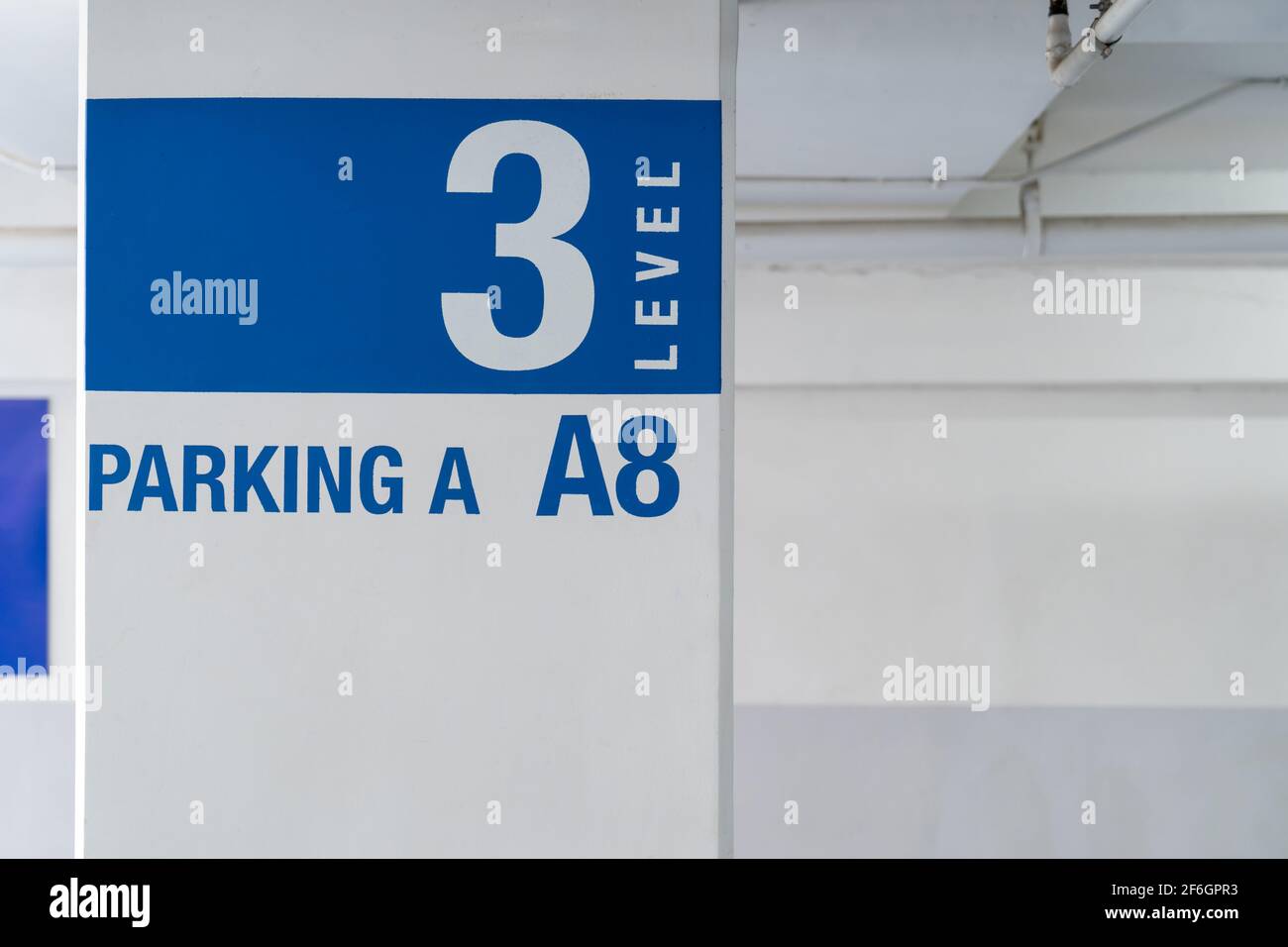 Signage on the indoor carparking pole, tell driver which way to go and ...