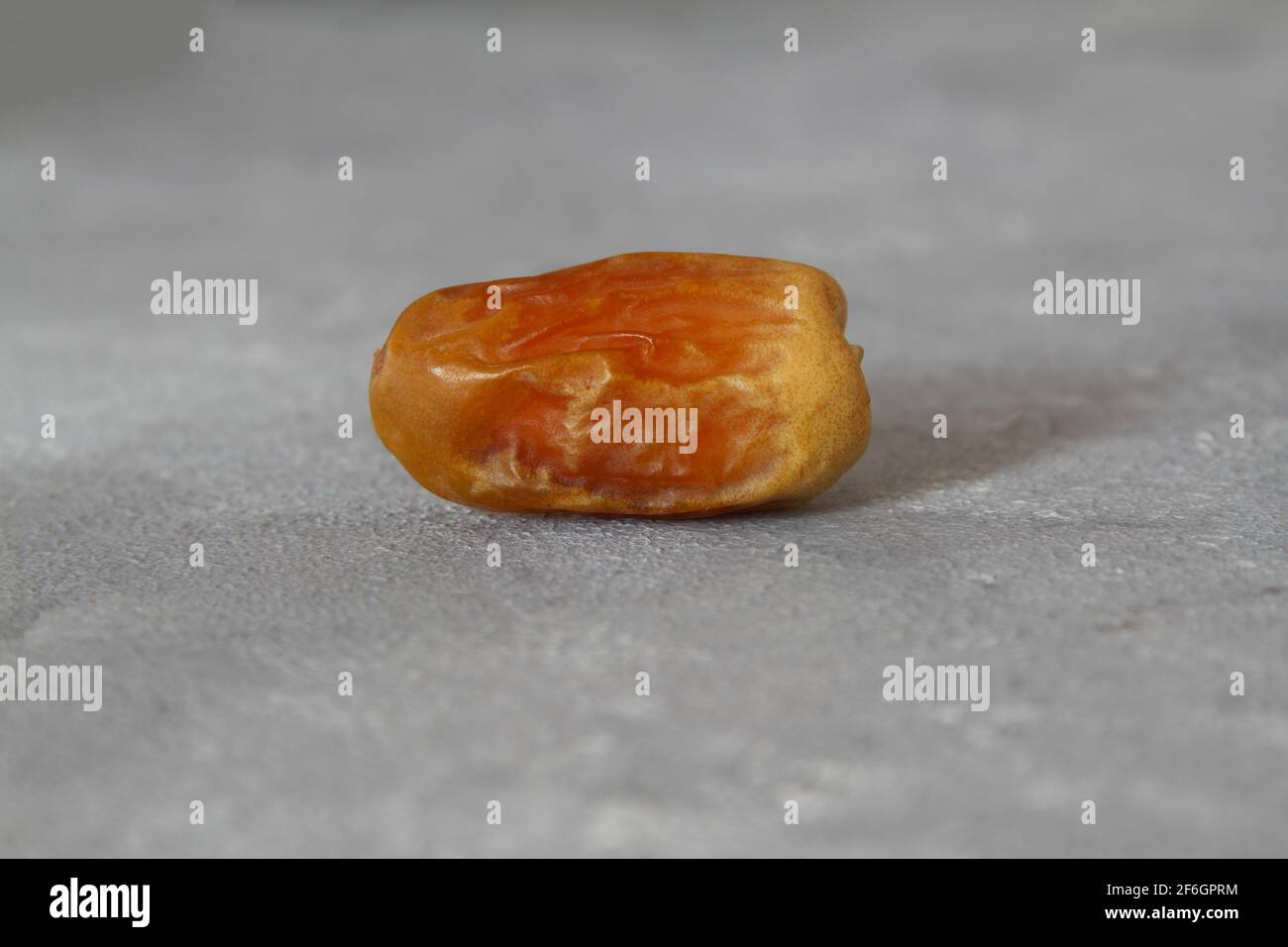 Dates on a stone background. Dried fruits. Dried dates lie next to each ...