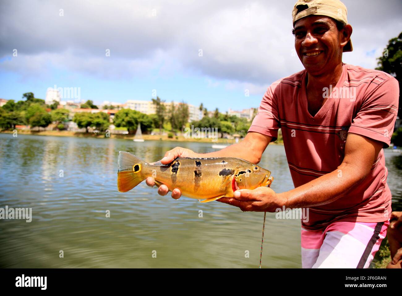 salvador, bahia brazil - december 4, 2020: fisherman shows the tucunare ...
