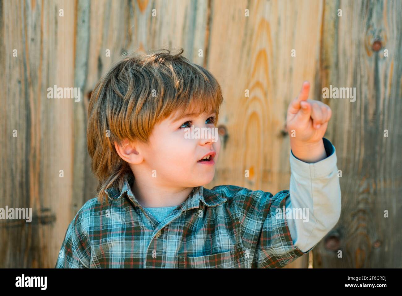 Cute kid pointing up. Learning and discovering. Happy childhood. Spring ...