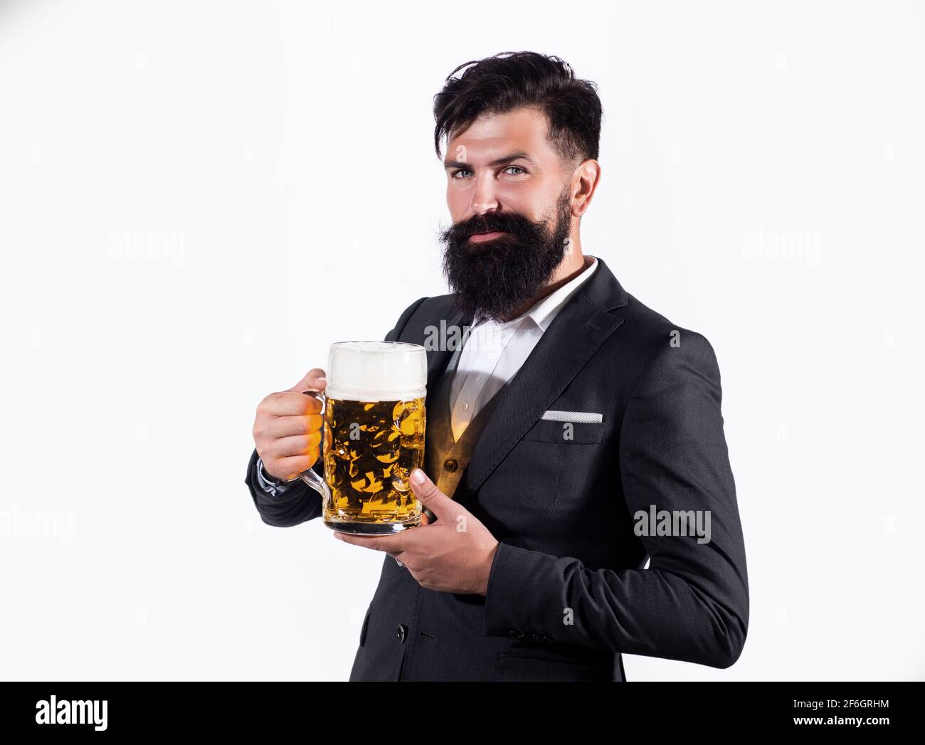Serious man in classic suit drinking beer. Bearded guy in business ...