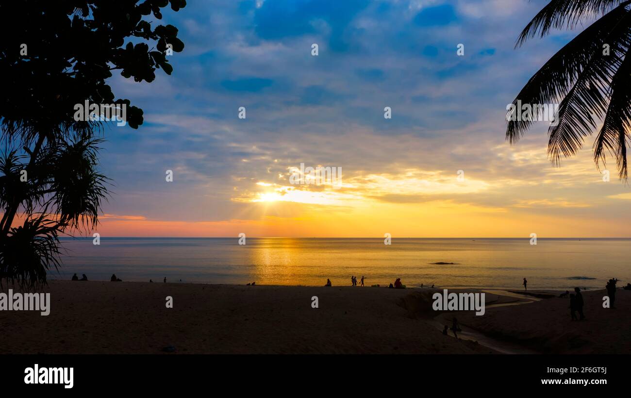 Silhouettes of group of people during the sunset in Seaside beach ...