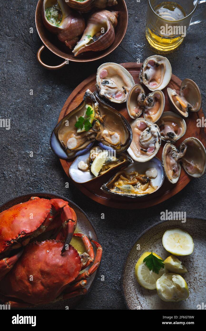 Fresh seafood shellfish mussels, clams, crabs and snails on gray ...