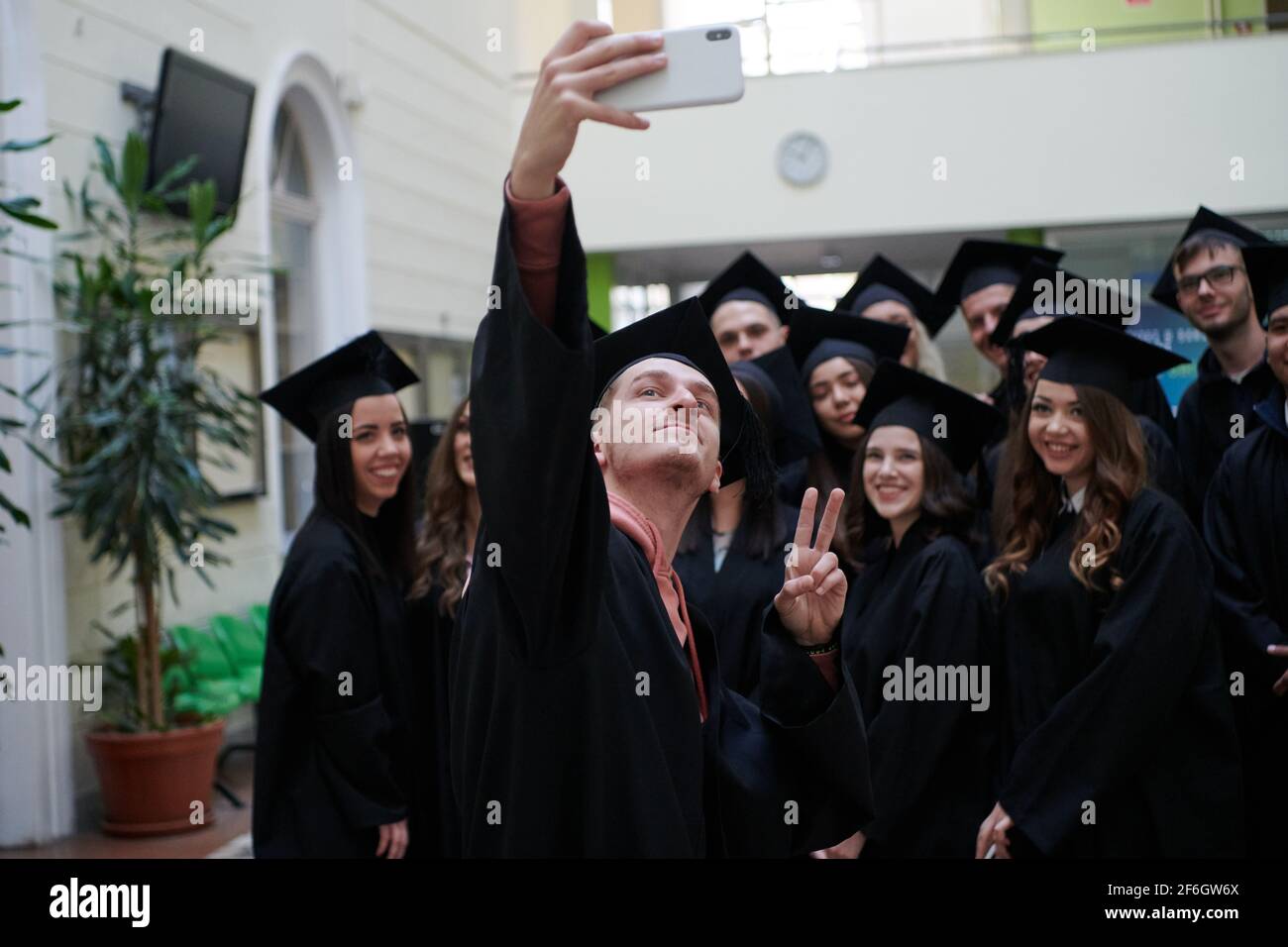 education, graduation, technology and people concept - group of happy ...