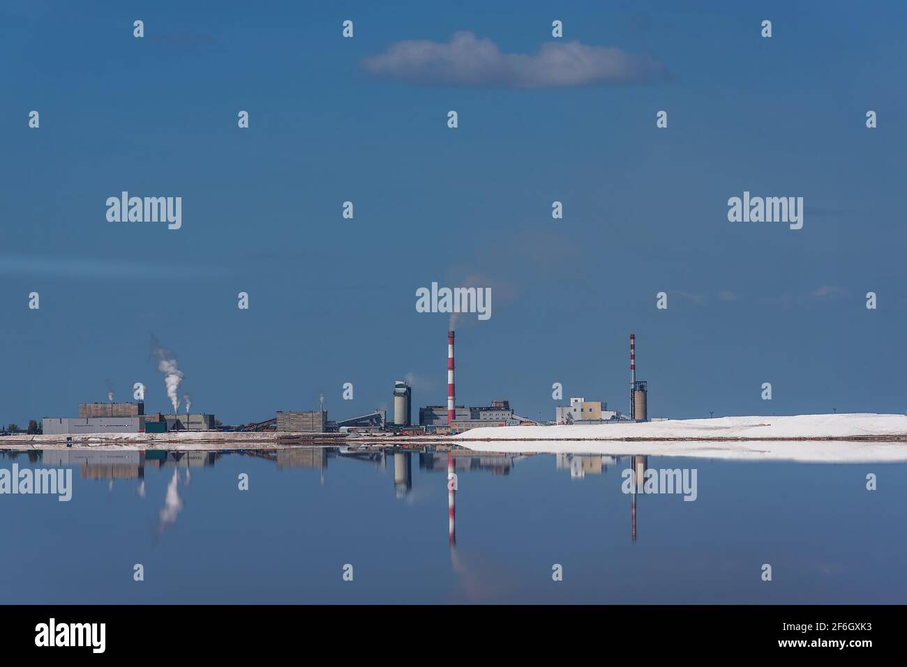 A scenic view of a sodium sulfate chemical plant standing on the shore ...