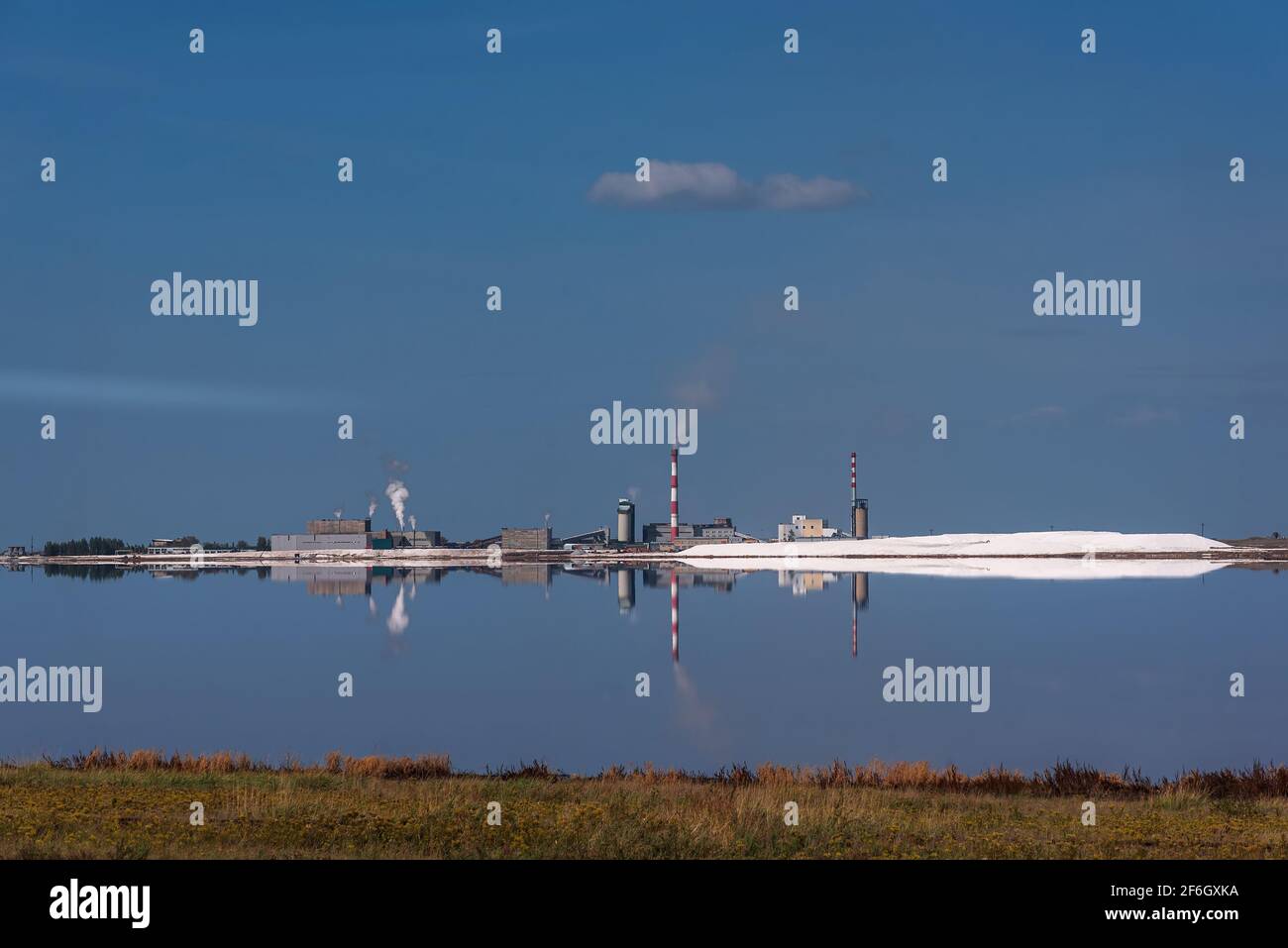 A scenic view of a sodium sulfate chemical plant standing on the shore ...