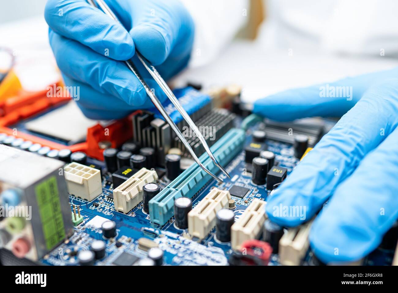 Technician repairing inside of hard disk. Integrated Circuit. the ...