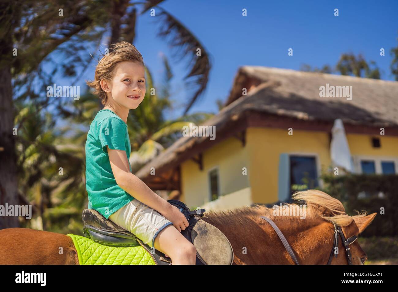 Happy boy riding pony horse hi-res stock photography and images - Alamy