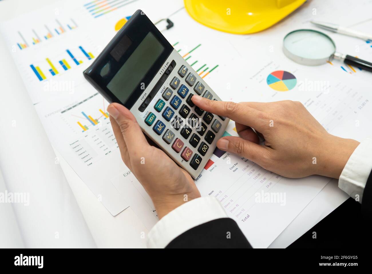 Asian accountant working and analyzing financial reports project ...