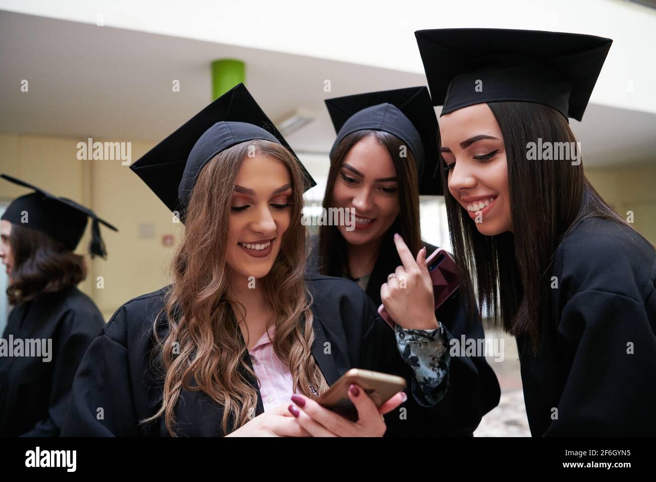 education, graduation, technology and people concept - group of happy ...