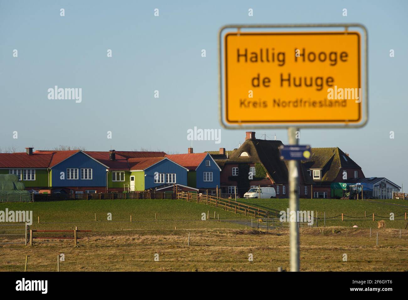 Hooge, Germany. 30th Mar, 2021. Colourful houses can be seen on a ...