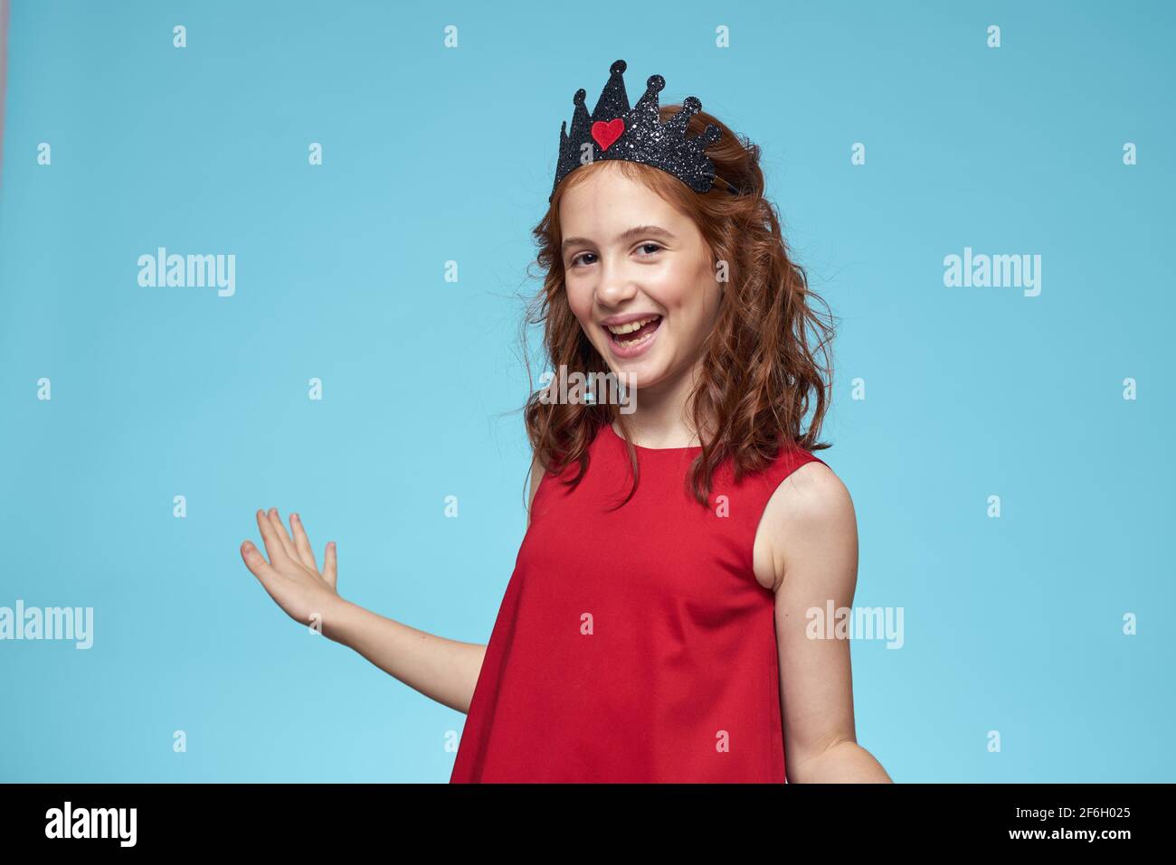 Girl with curly hair with a crown on her head red dress lifestyle blue ...