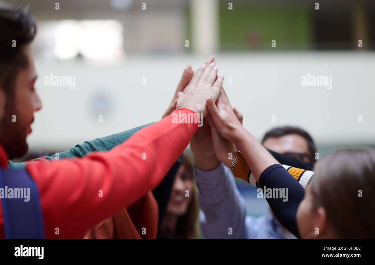 Students putting hands together in hi-res stock photography and images ...