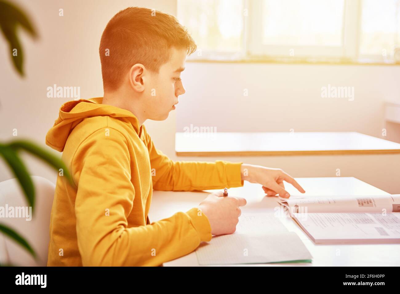 Teenage boy writing homework at home. Education concept Stock Photo - Alamy