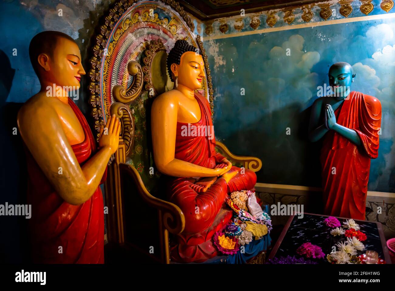 Ancient colorful statue of Buddha and monks in Ella Temple in Ella town ...
