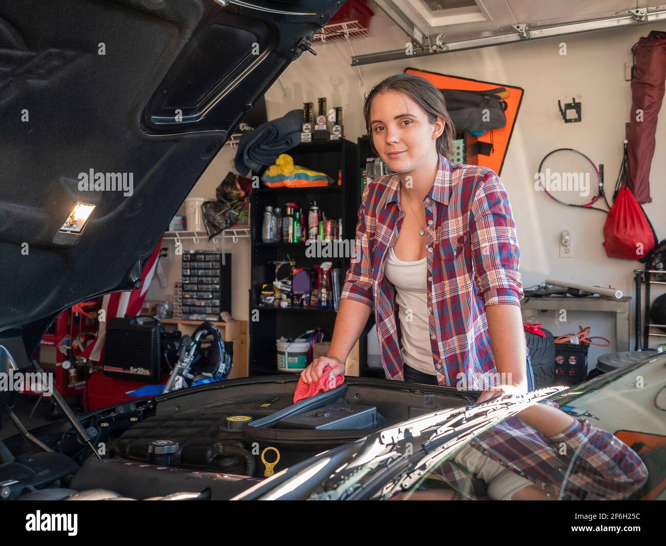 Woman fixing car in garage Stock Photo - Alamy
