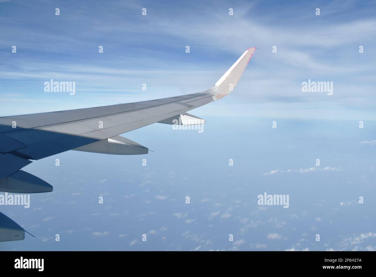plane wing and cloud floating on sky through window frame Stock Photo ...