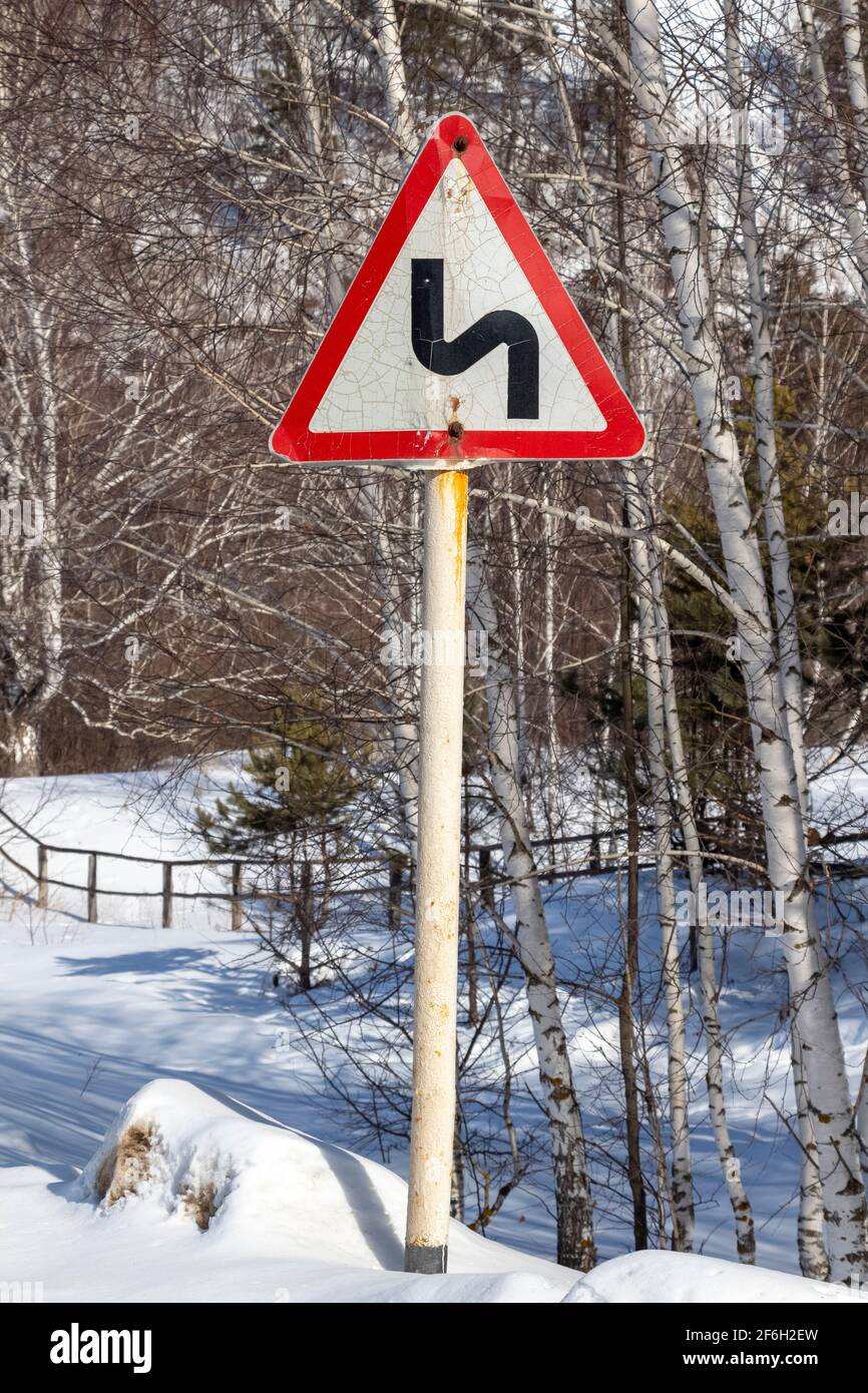 A road sign warning of upcoming tight bends Stock Photo - Alamy
