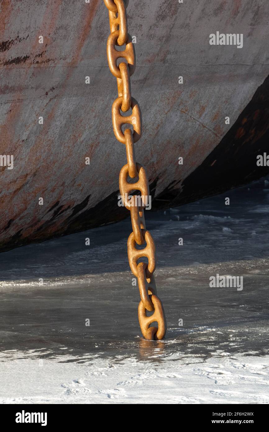 A rusty chain of an old anchor frozen into the ice Stock Photo - Alamy