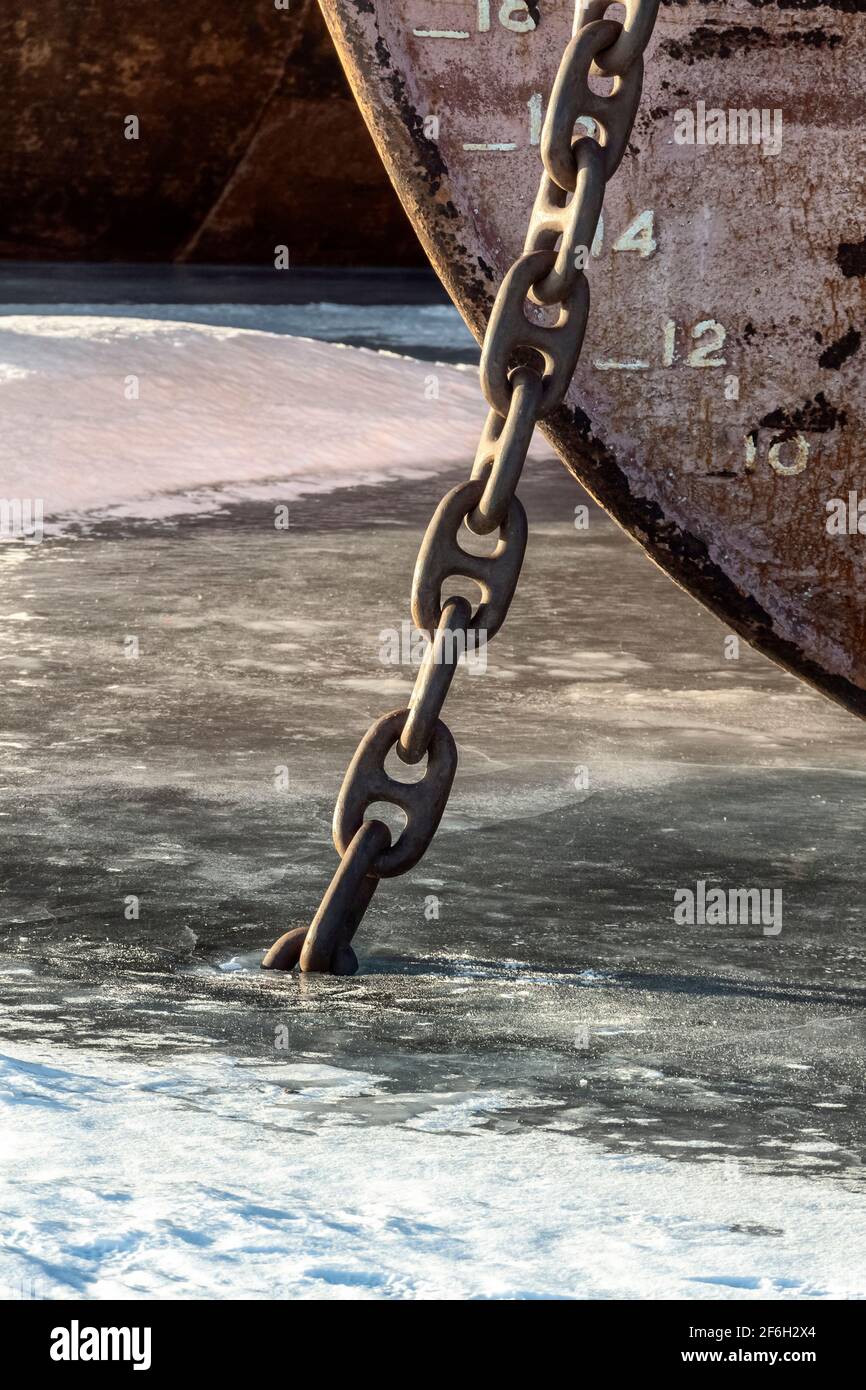 A rusty chain of an old anchor frozen into the ice Stock Photo - Alamy