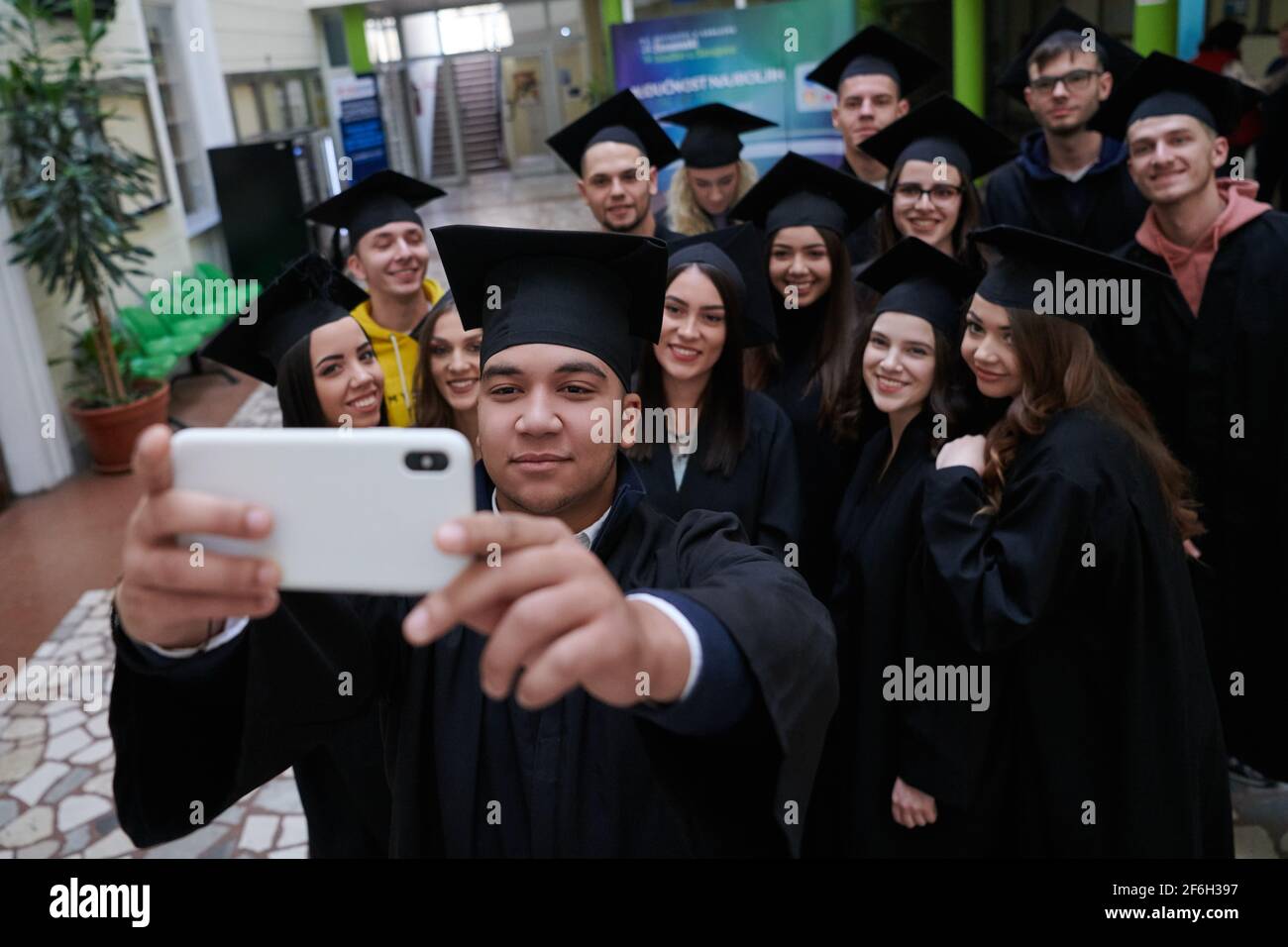 education, graduation, technology and people concept - group of happy ...
