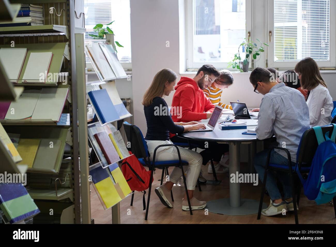 students in a modern environment work together to more easily complete ...