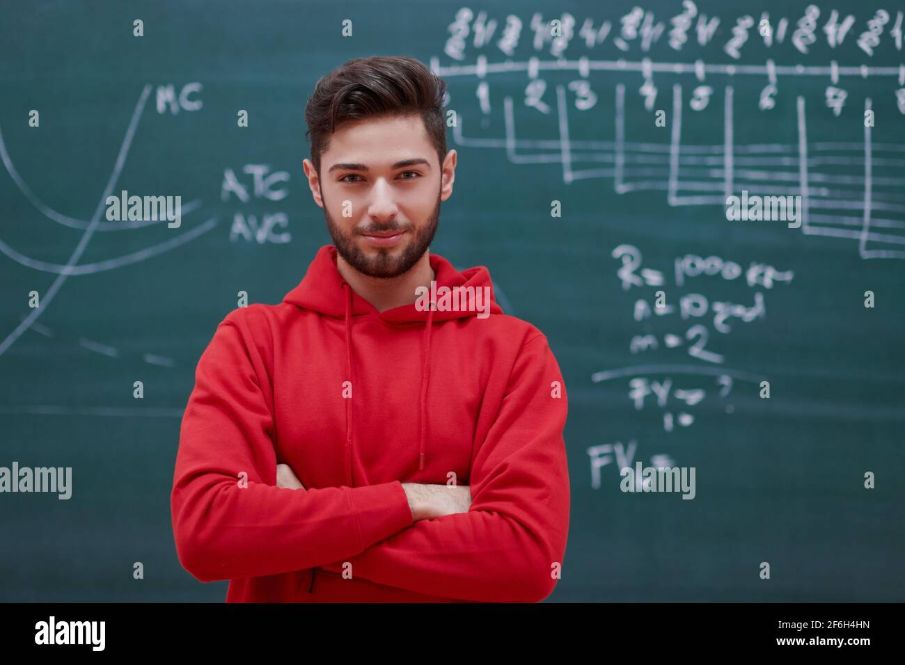a portrait of a determined student in front of a school board Stock ...