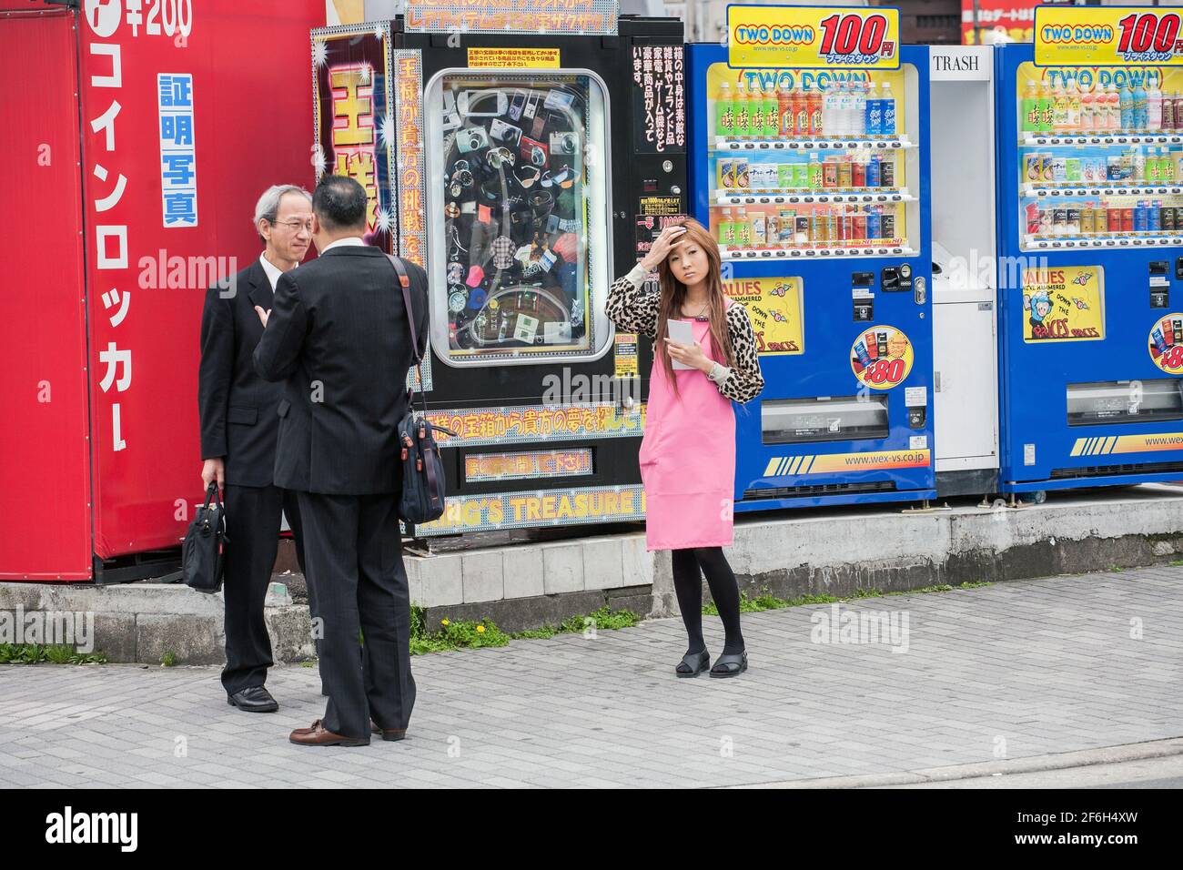 Pretty promo girl leafletting in front of vending machines, Ikebukuro ...