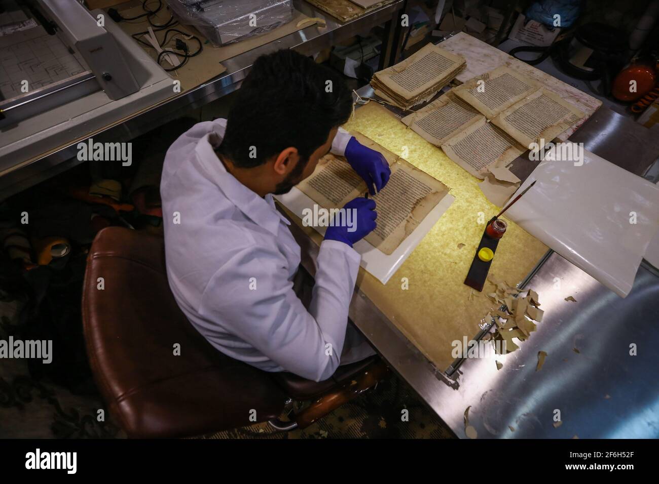 Najaf, Iraq. 22nd Mar, 2021. Restorer Mostafa Majed works on a ...