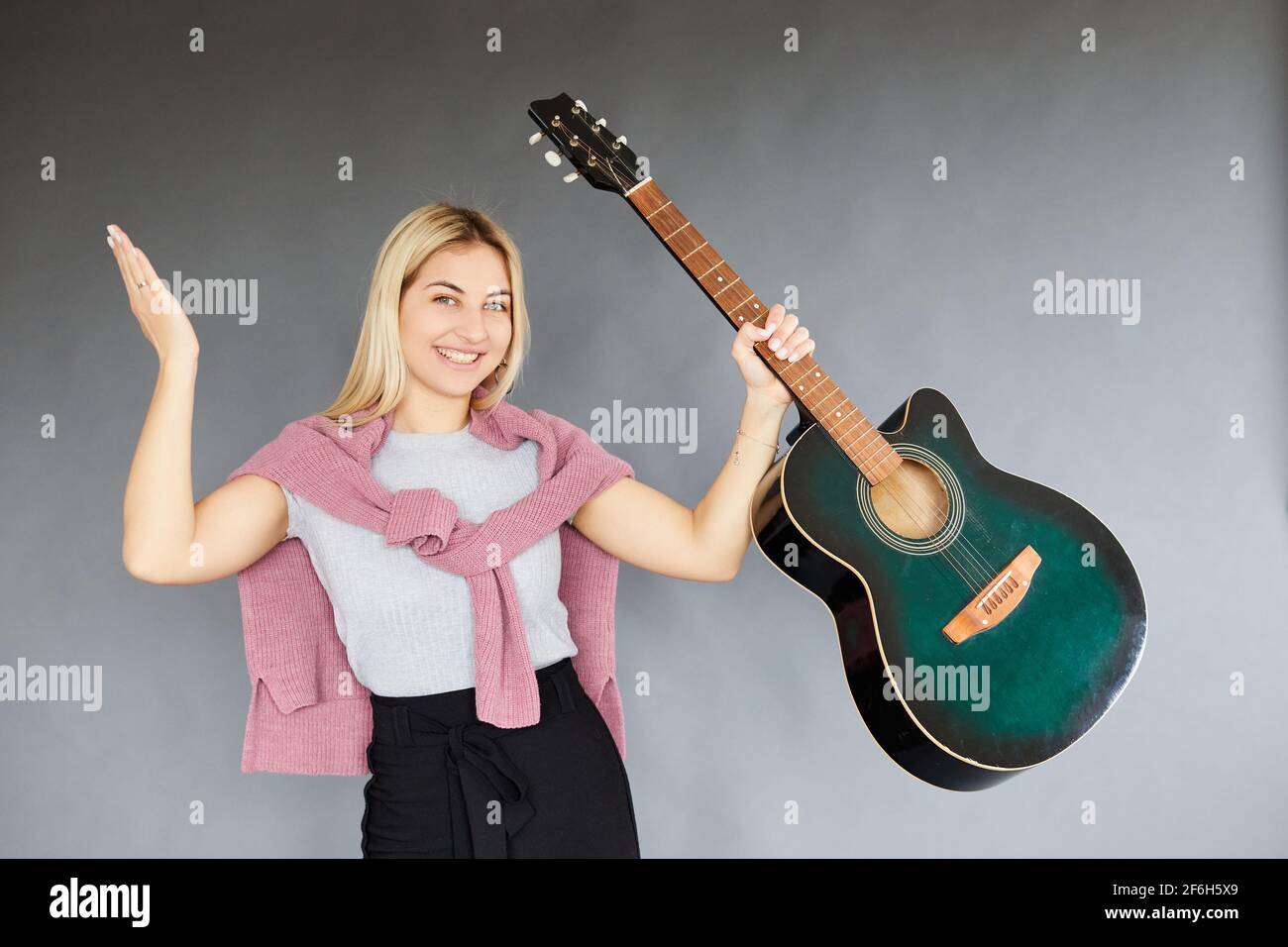 Happiness young woman play music with acoustic guitar on blue ...