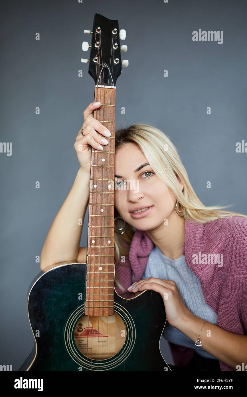 Happiness young woman play music with acoustic guitar on blue ...
