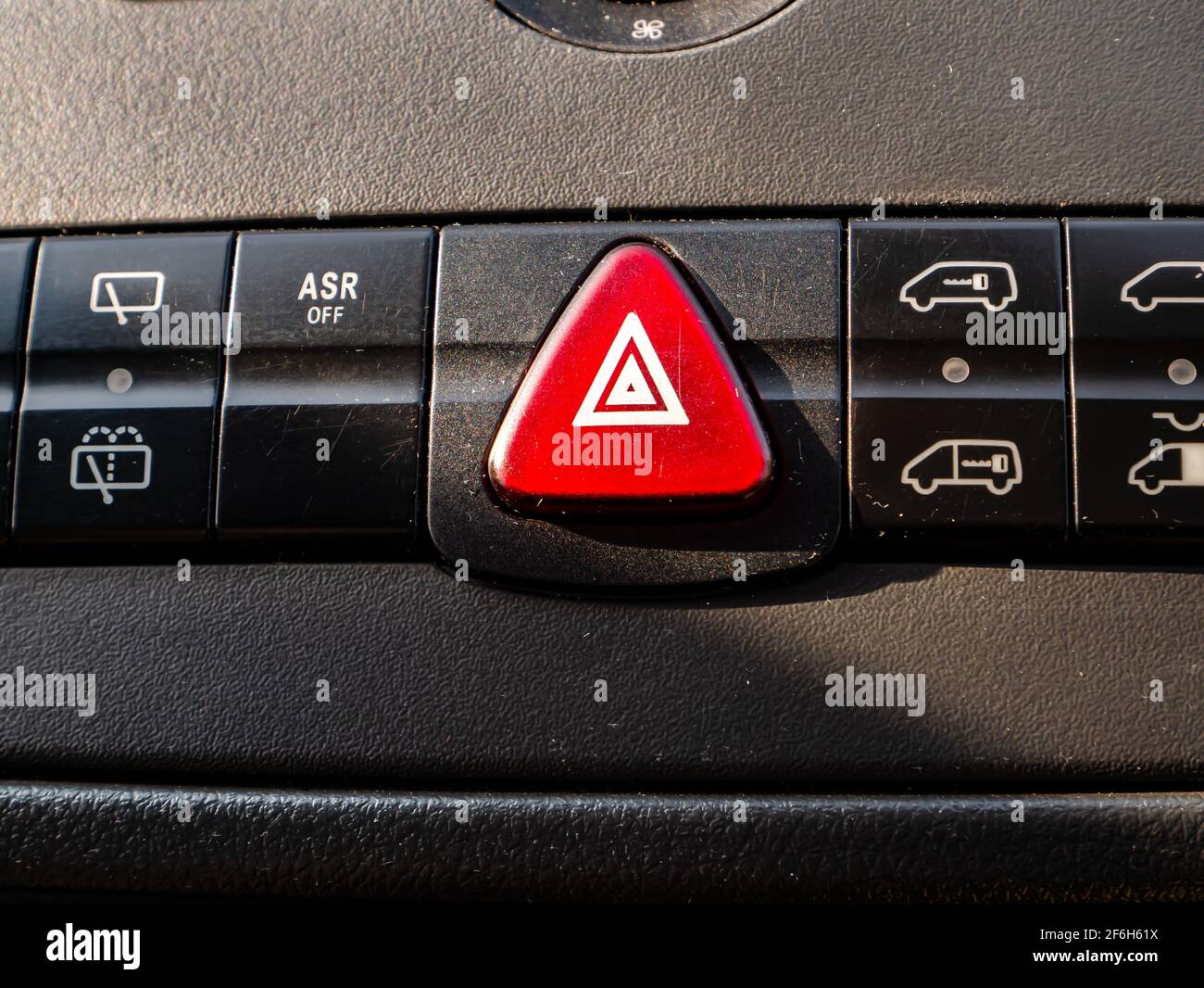 Red triangular car alarm button on the dashboard. Car alarm. Red button ...