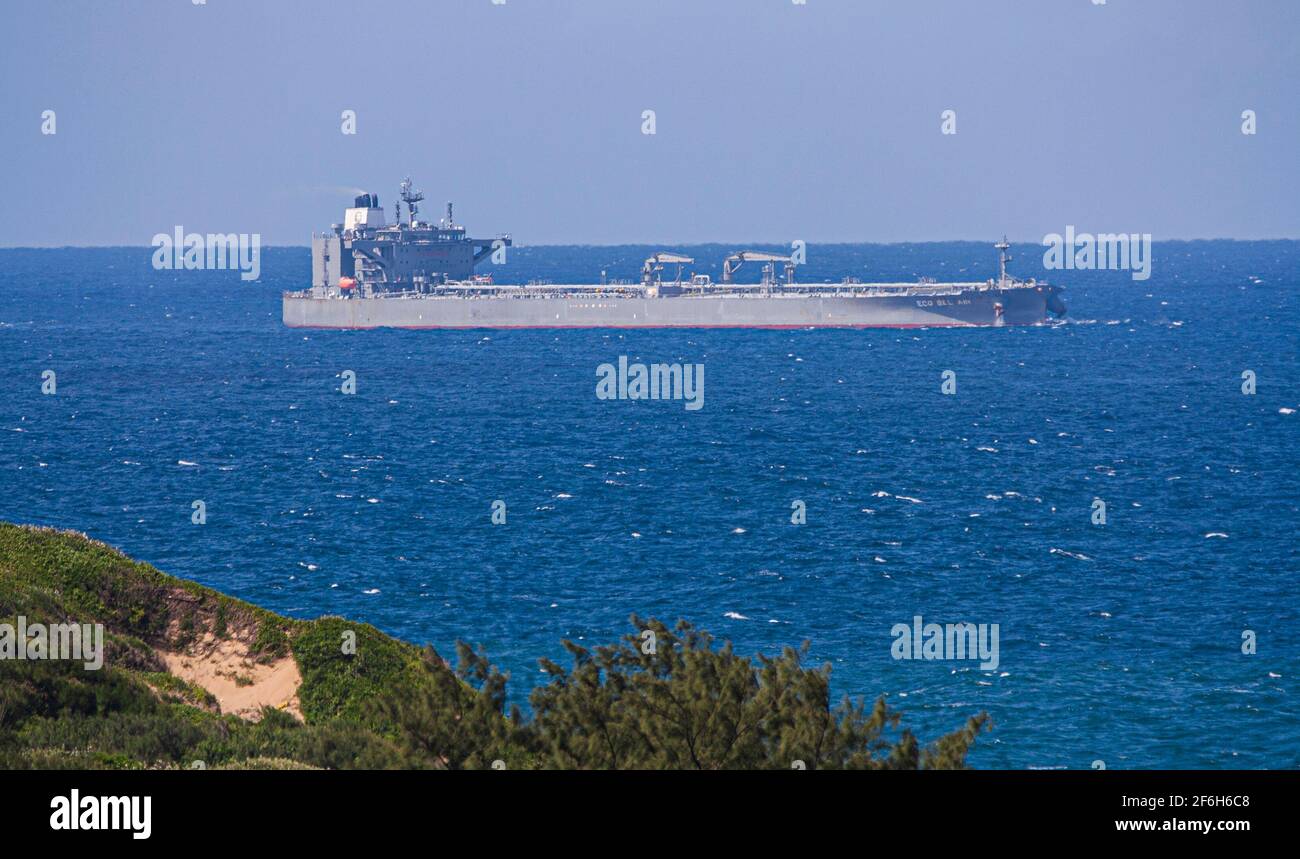 Large commercial ship in blue waters off shore Stock Photo - Alamy