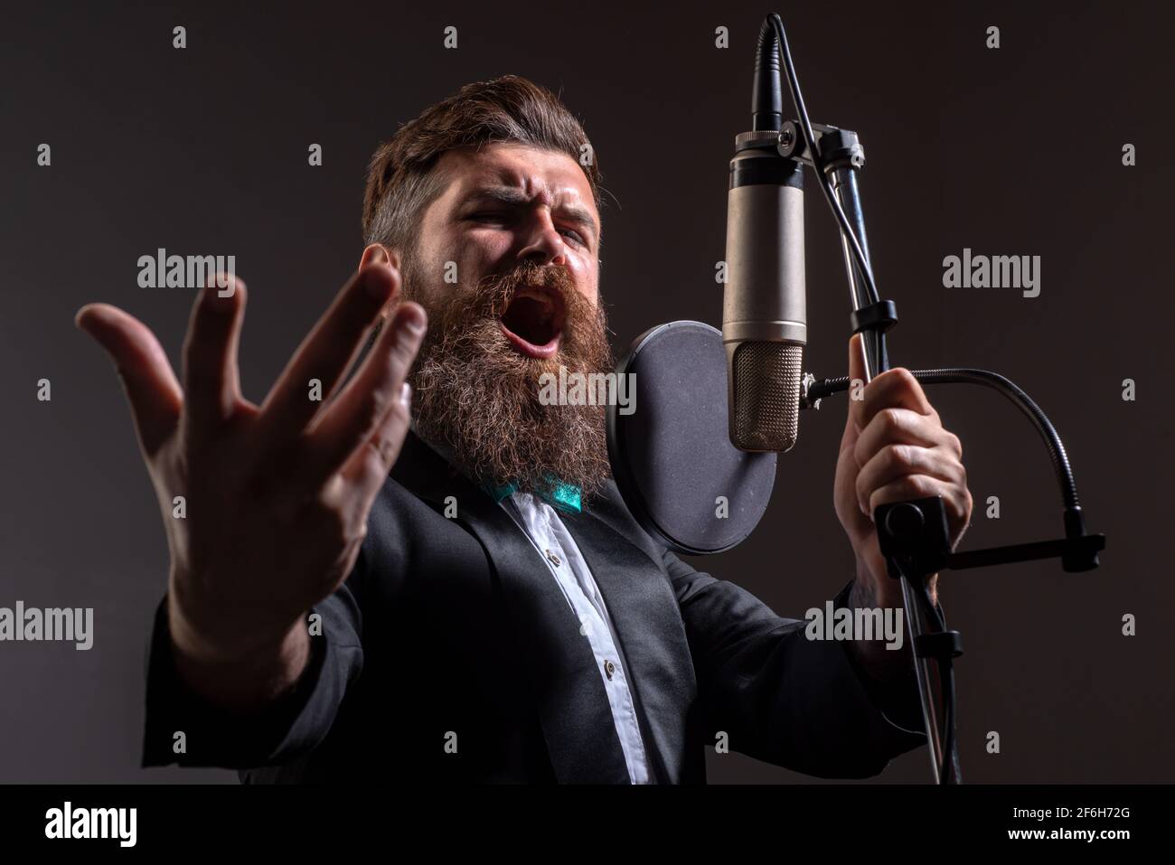 Classic singer in suit. Handsome man in recording studio. Music ...