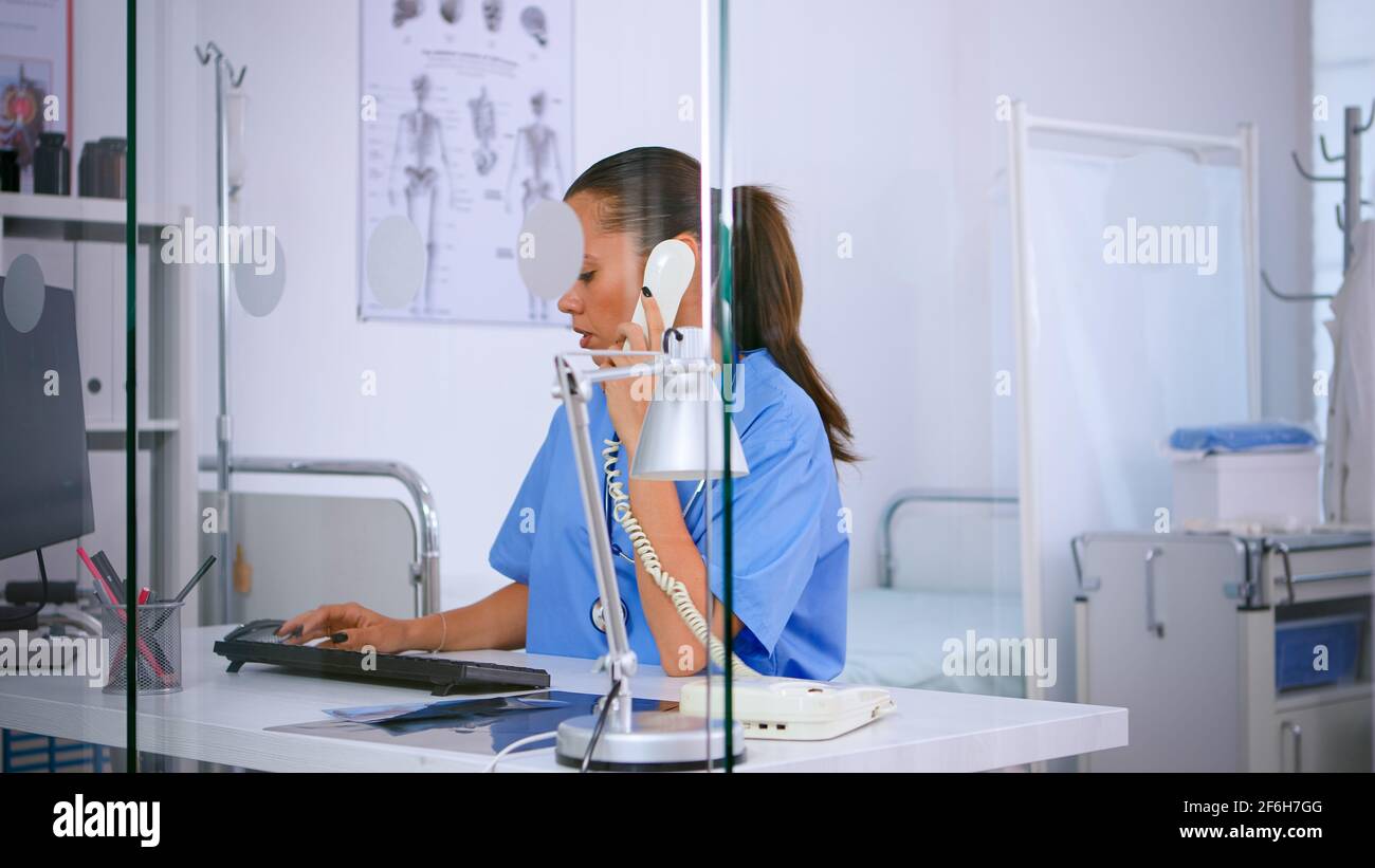 Healthcare physician answering phone calls from patient in hospital ...