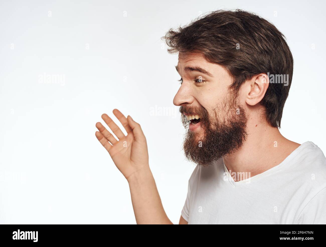 Portrait of a man side view light background white t-shirt model Stock ...