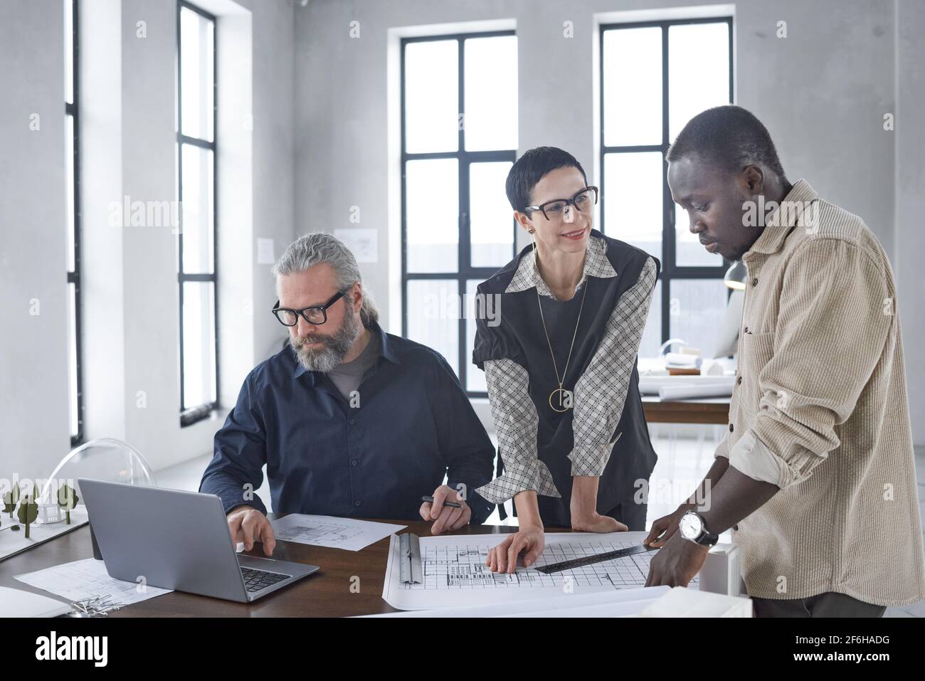 Group of architects working in team at the table they using laptop and ...