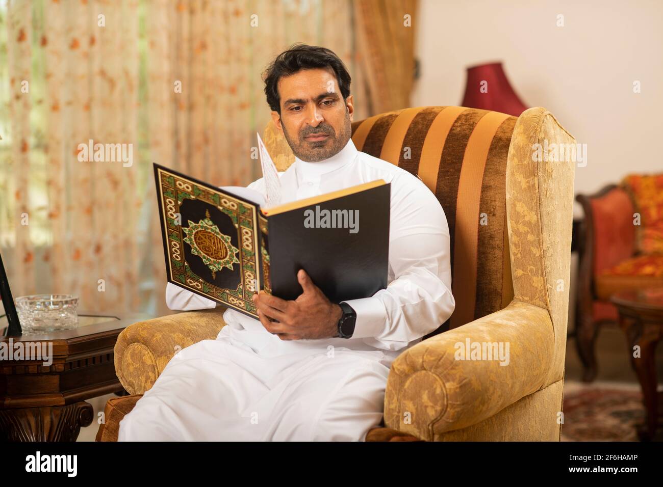 Arab Muslim man reading the holy book the Quran Kareem Stock Photo - Alamy