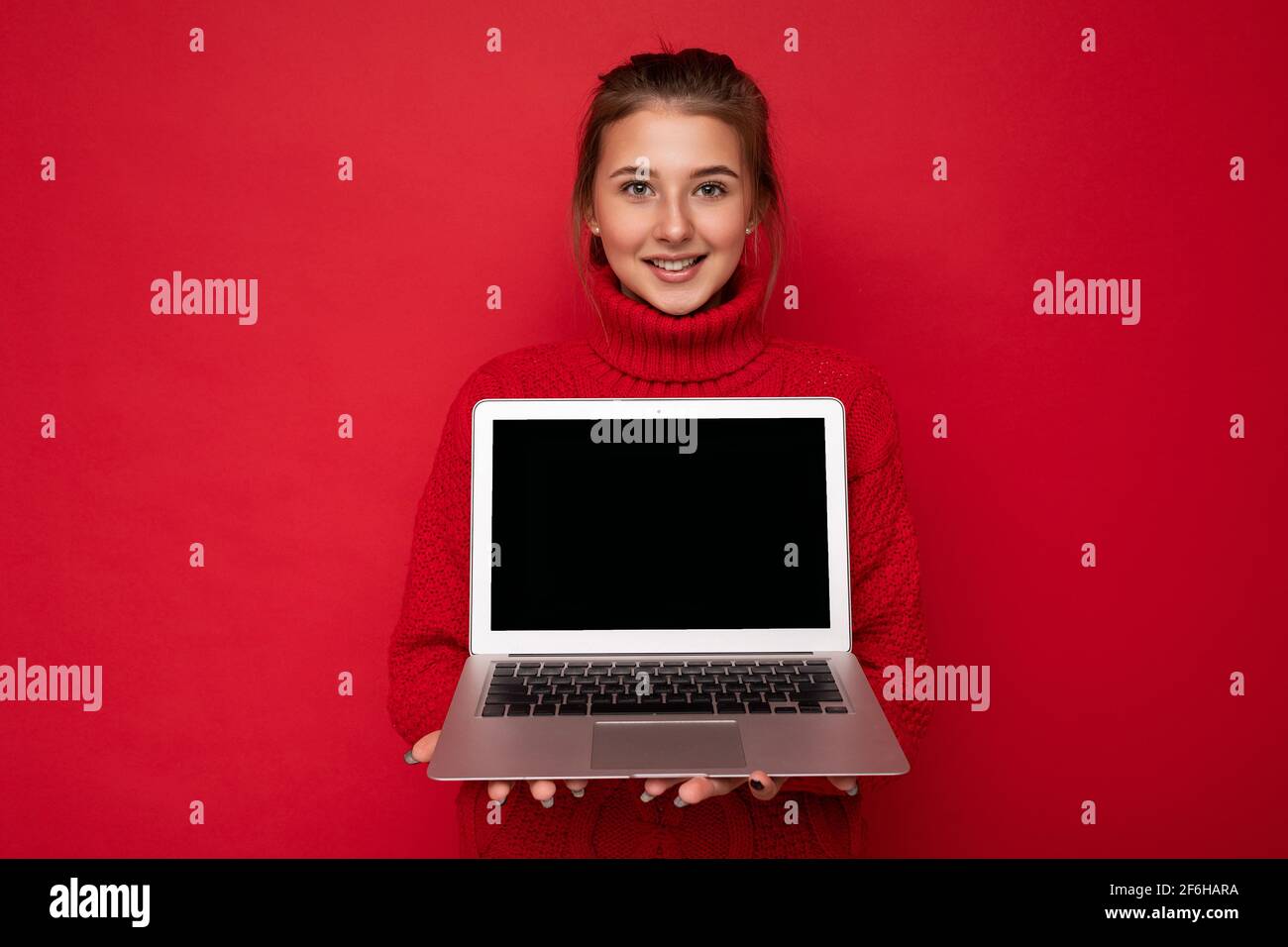 Photo of Beautiful satisfied happy young woman holding computer laptop ...