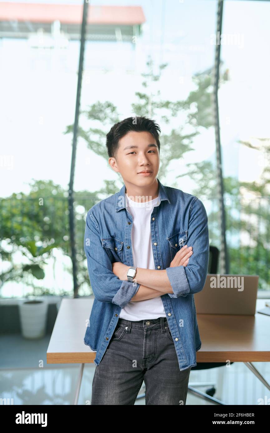 Professional man leaning against desk hi-res stock photography and ...